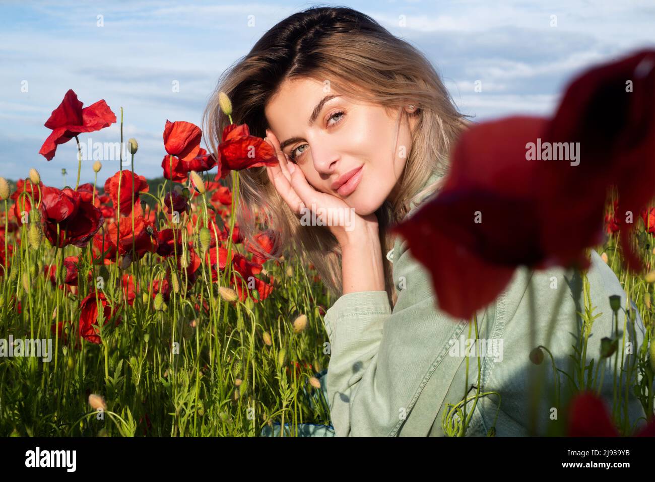 Beautiful young woman in poppy field. Woman on flowering poppy field ...
