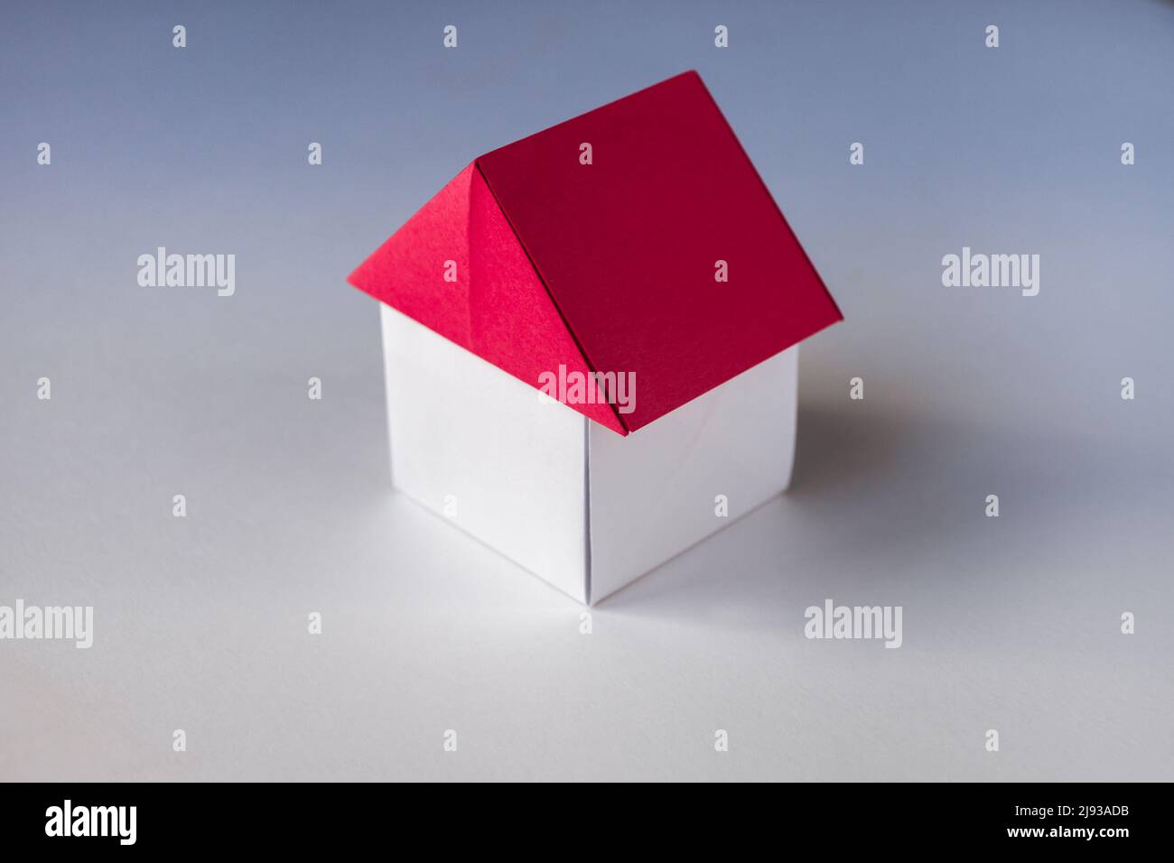 White and red paper house origami isolated on a blank background Stock ...