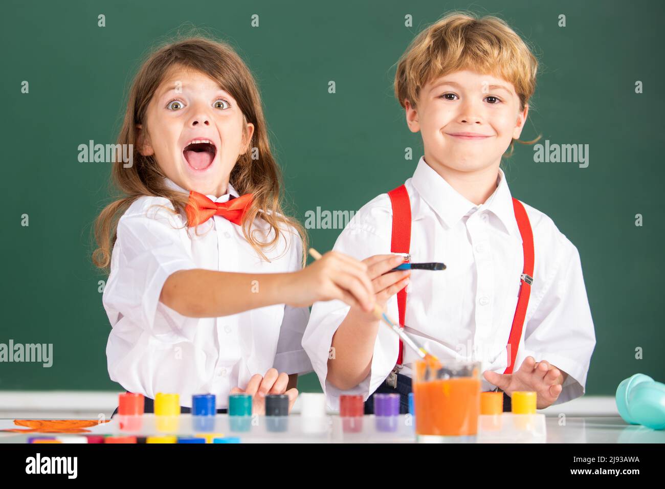 Funny excited children girl and boy drawing with coloring pens. Cute ...