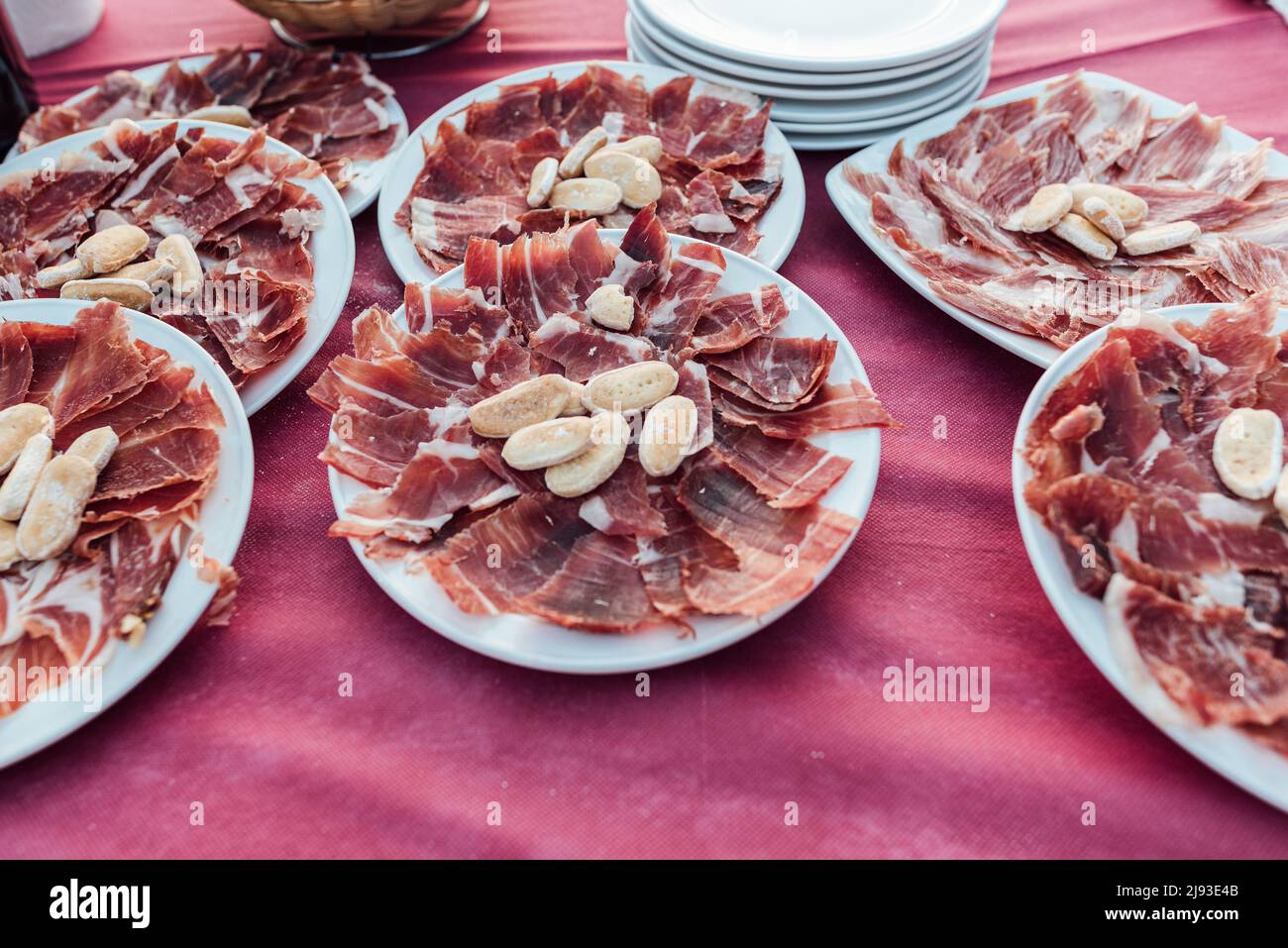 Delicious serrano ham appetizer served on plates at a party buffet ...