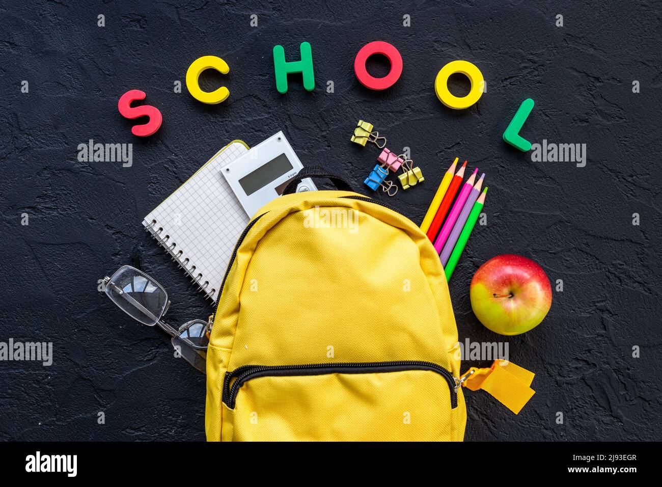 School backpack with school items and students equipment, top view ...