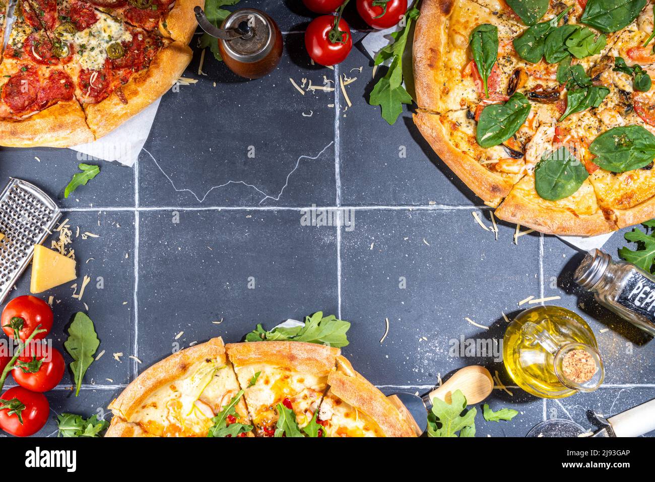 Three various pizzas, served at home or in restaurant on tiled table ...