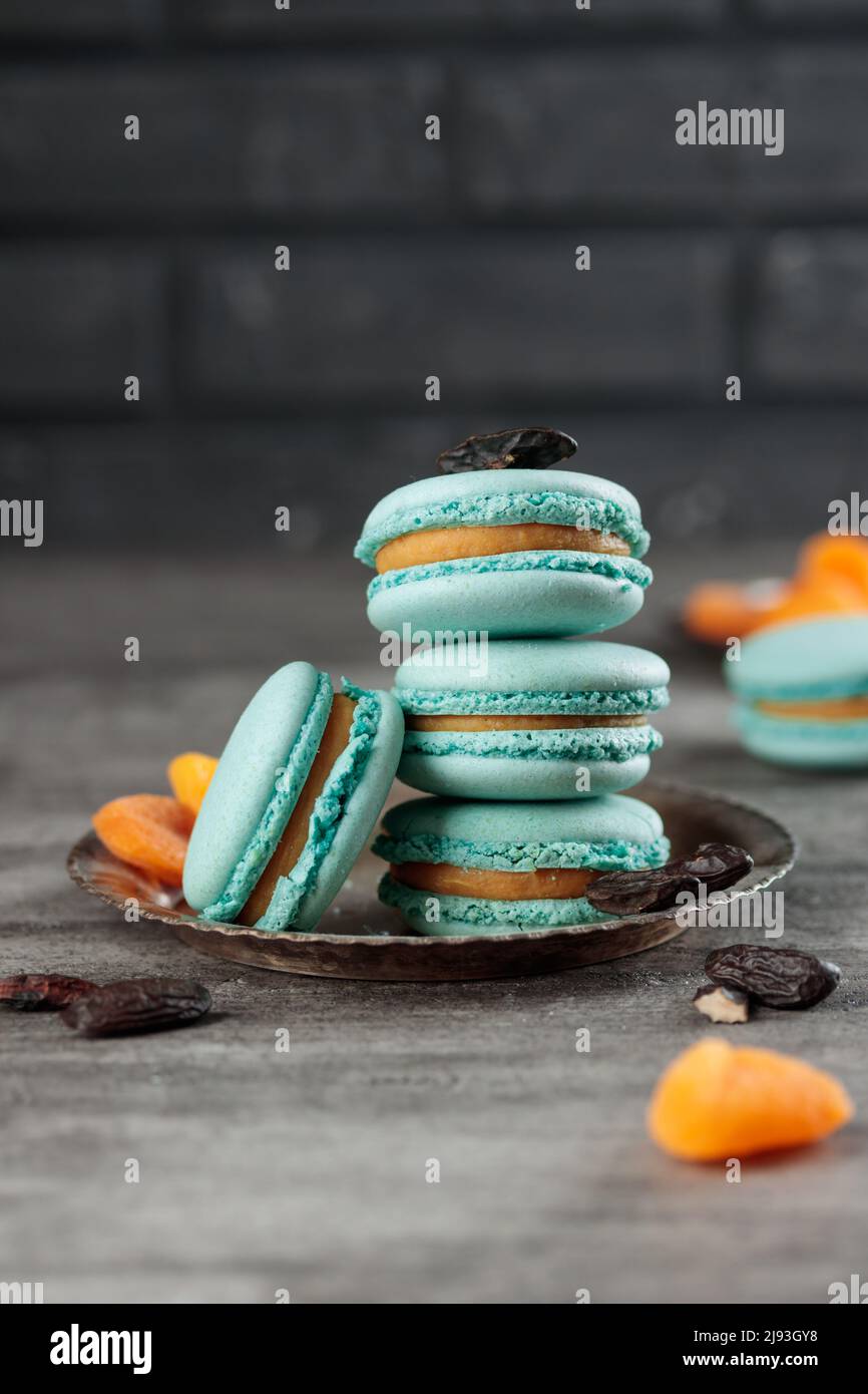 Blue macaroons on a grey concrete background. Vertical Stock Photo - Alamy