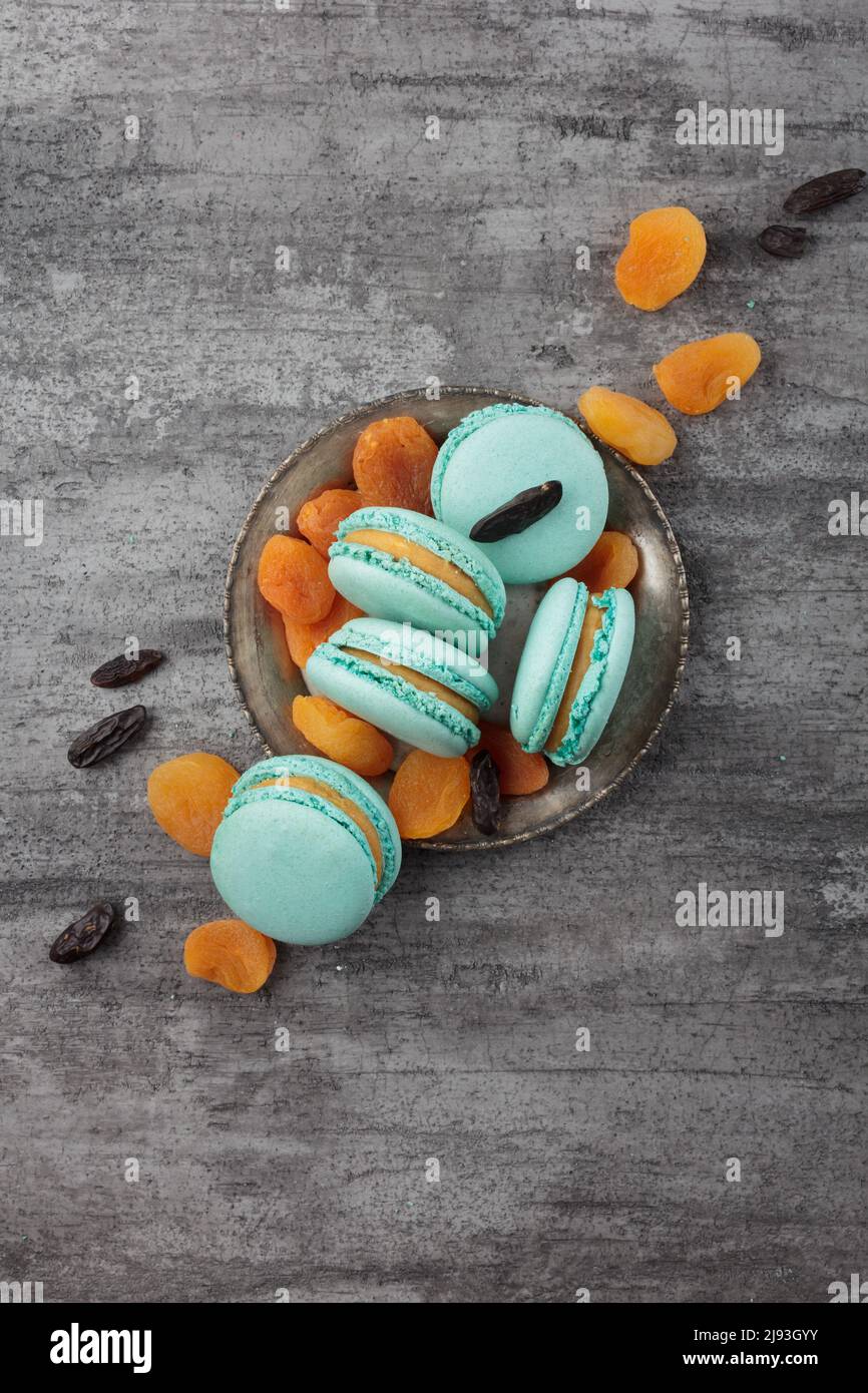 Blue macaroons on a grey concrete background. Vertical Stock Photo - Alamy