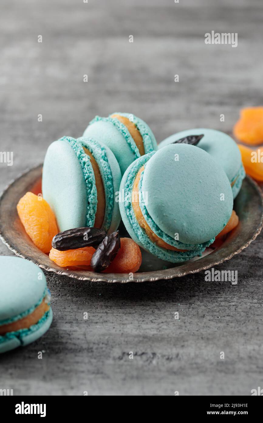 Blue macaroons on a grey concrete background. Vertical Stock Photo - Alamy