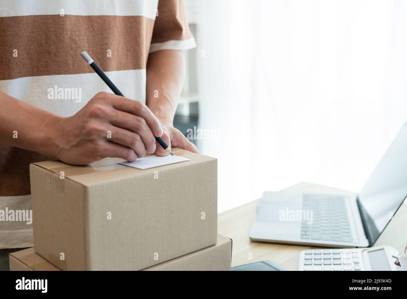 Online shopping concept the seller writing his customer’s address on ...