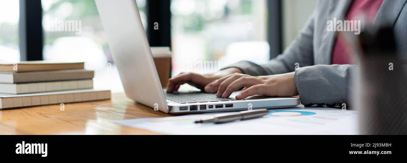 Business analyst concept the female officer typing financial ...