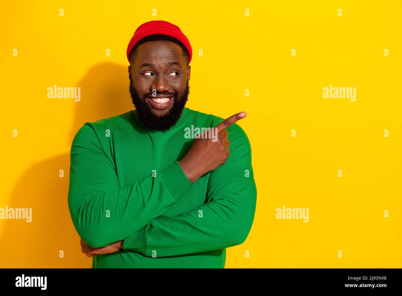 Photo of curious guy direct finger empty space look side wear red ...