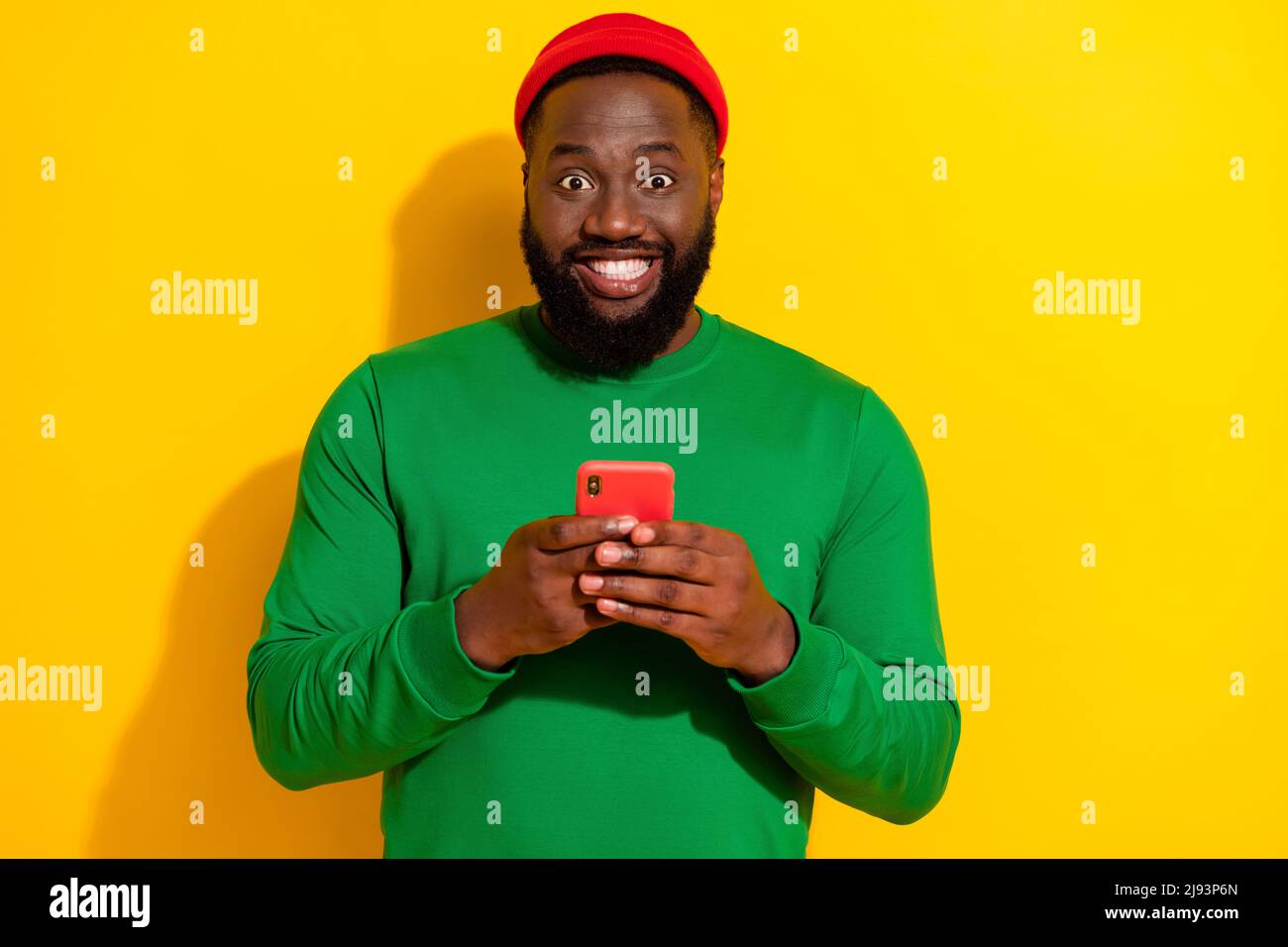 Portrait of attractive cheerful guy using device chatting post ...