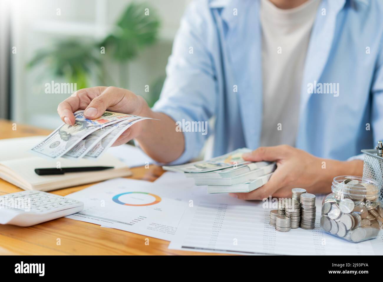 Saving concept the male money collector arranging his cash and coins on ...