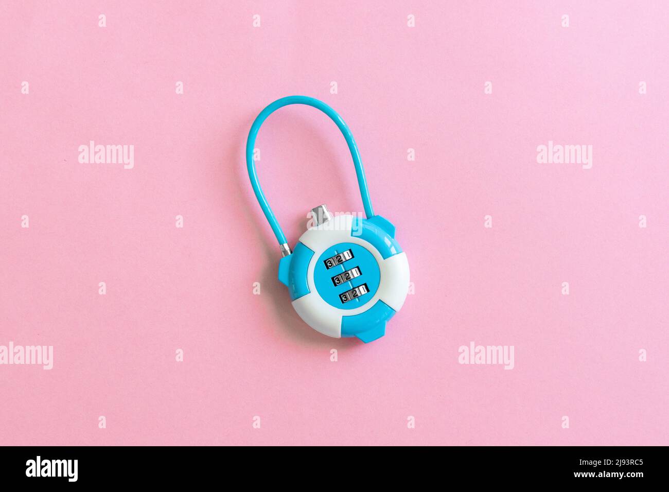 Combination lock on light pink background. Password sign. Close up, top ...