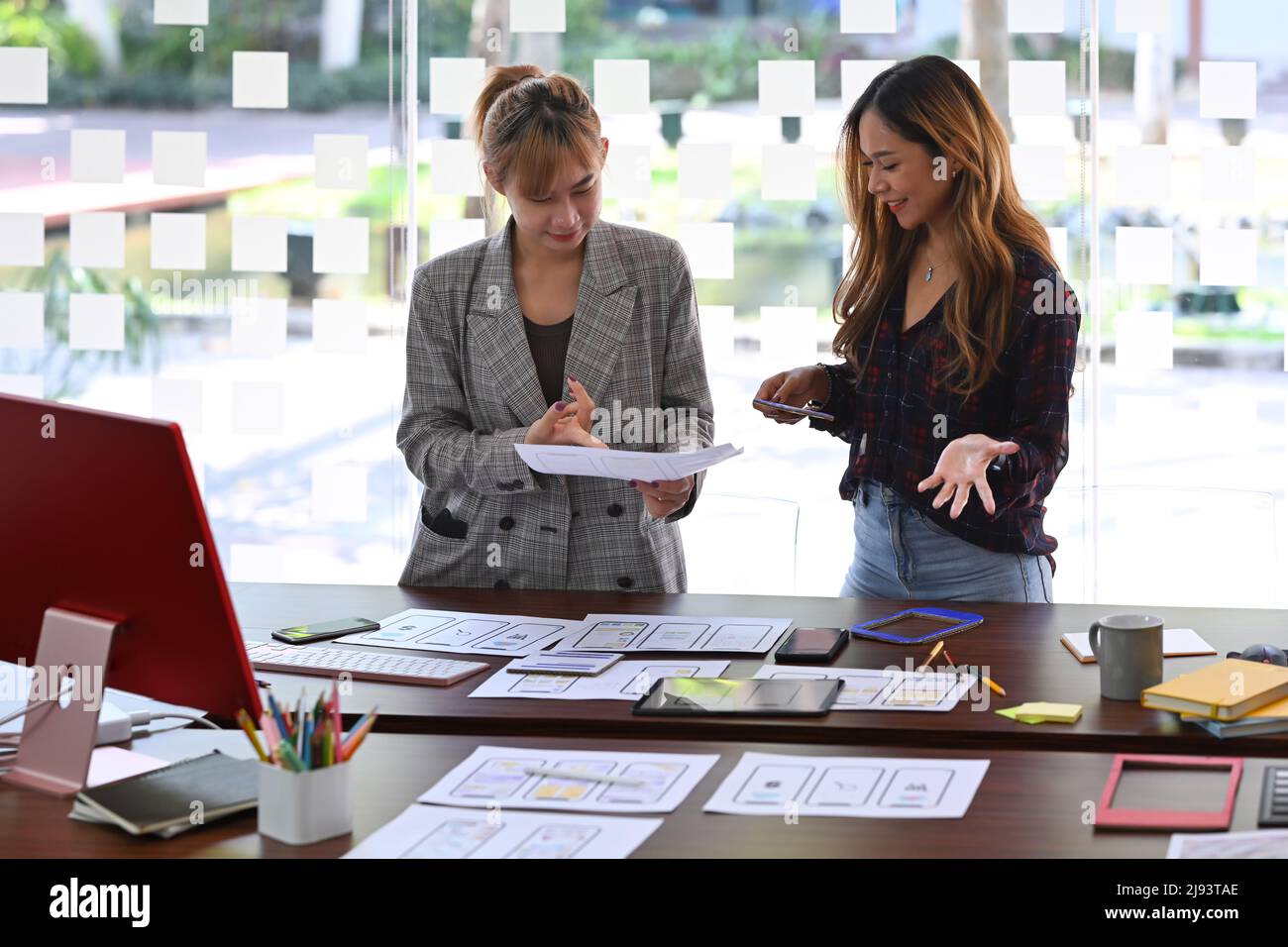 Two Creative Women Are Planning Application And Developing Template Layout Framework For Mobile