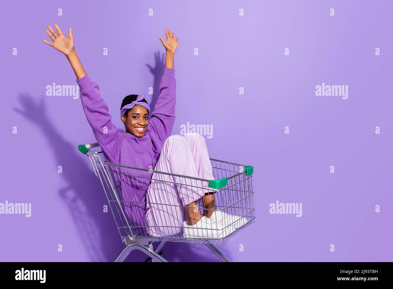 Photo of positive transgender sit trolley raise hands have fun wear ...