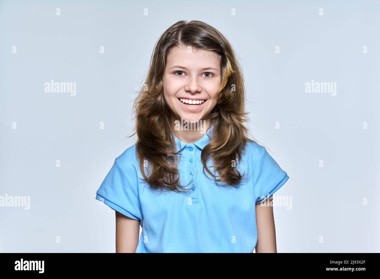 Portrait of schoolgirl 11, 12 years old, girl looking at camera on ...