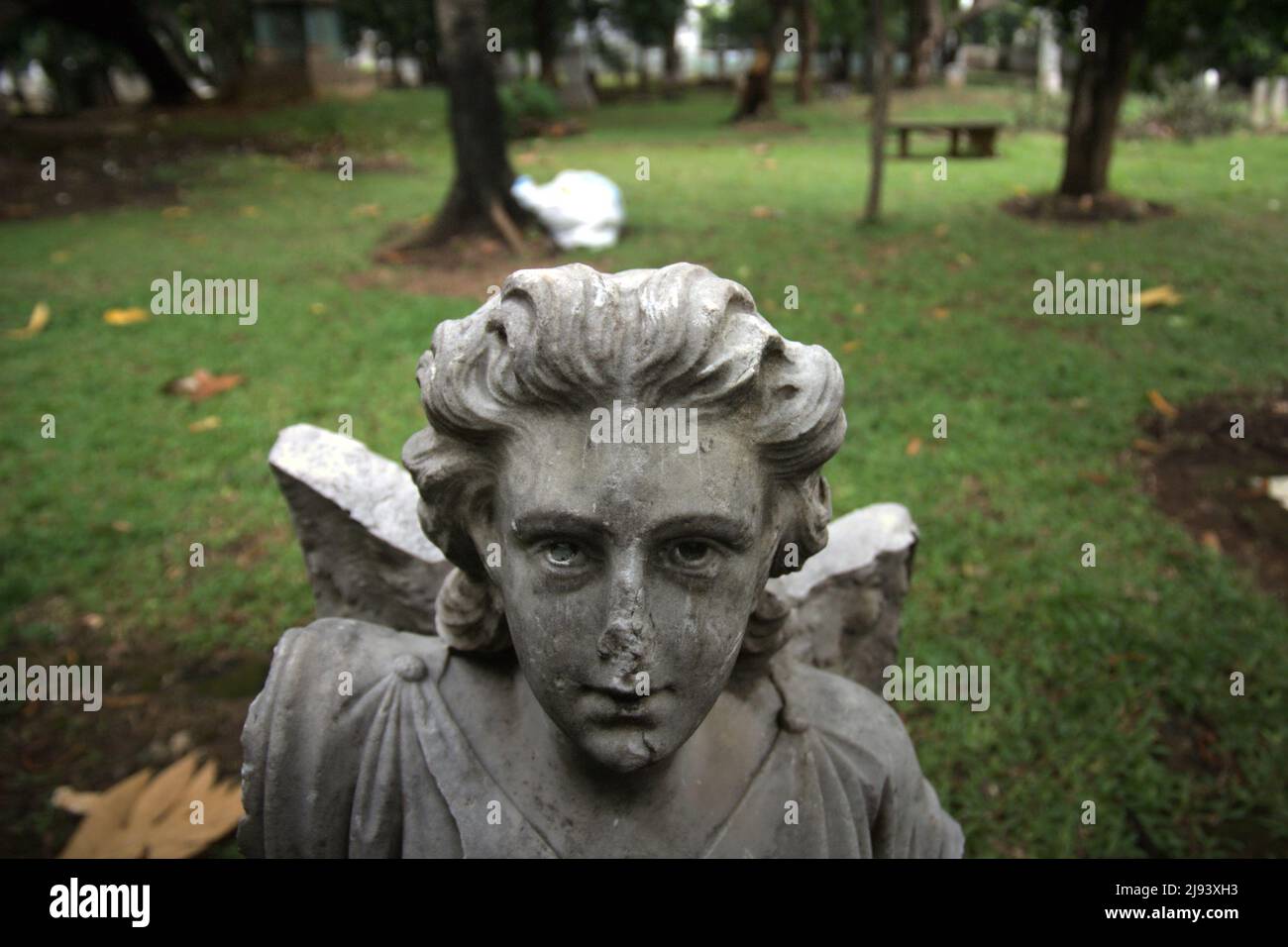 A broken statue of an angel figure at Taman Prasati museum (museum of ...