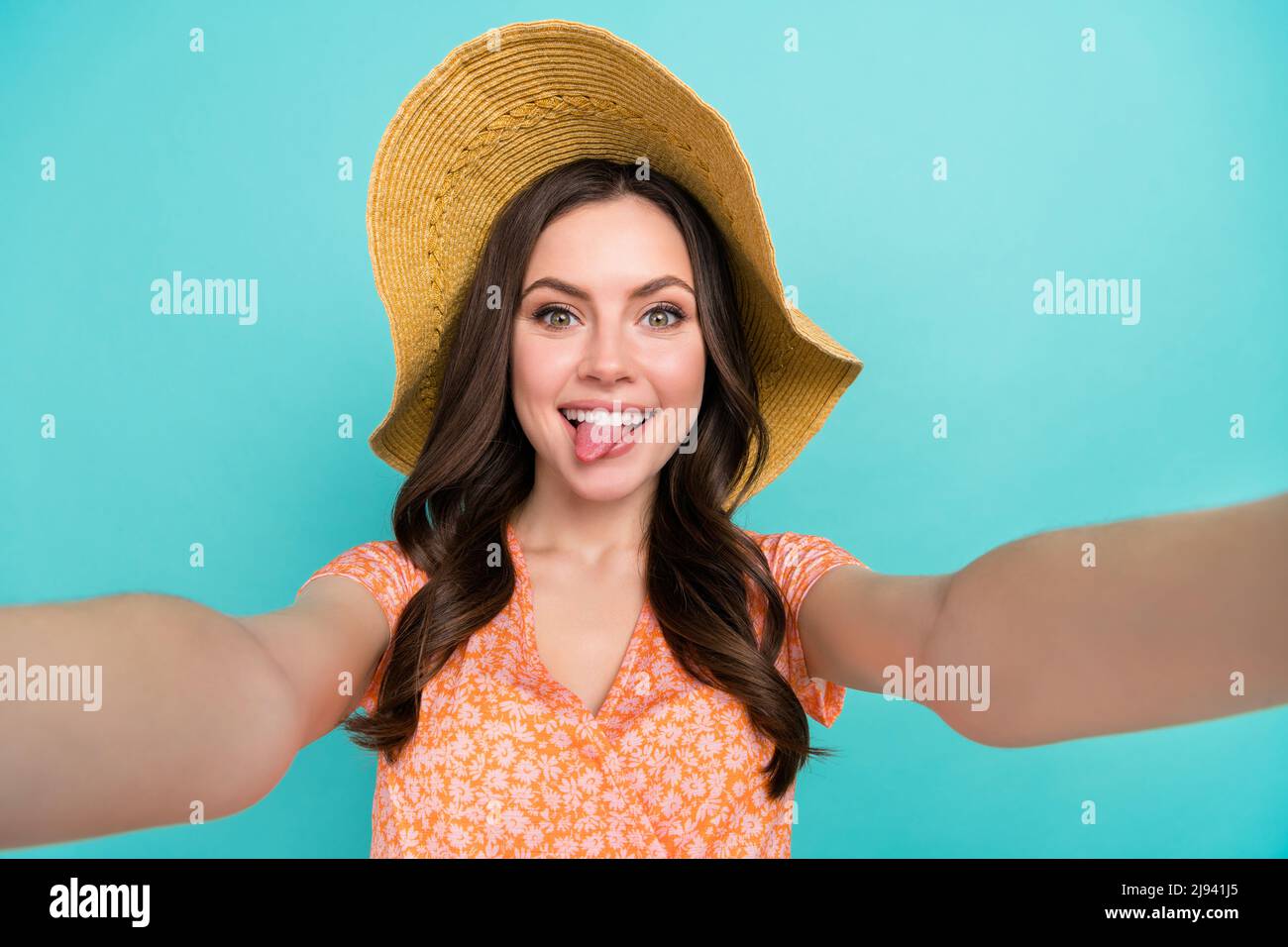 Photo of cute funny woman wear orange outfit panama showing tongue ...