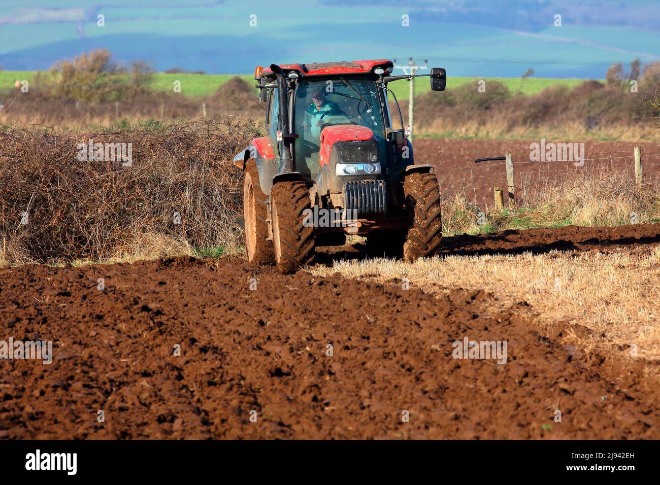 Field preparation for the next crop with the field being ploughed using ...