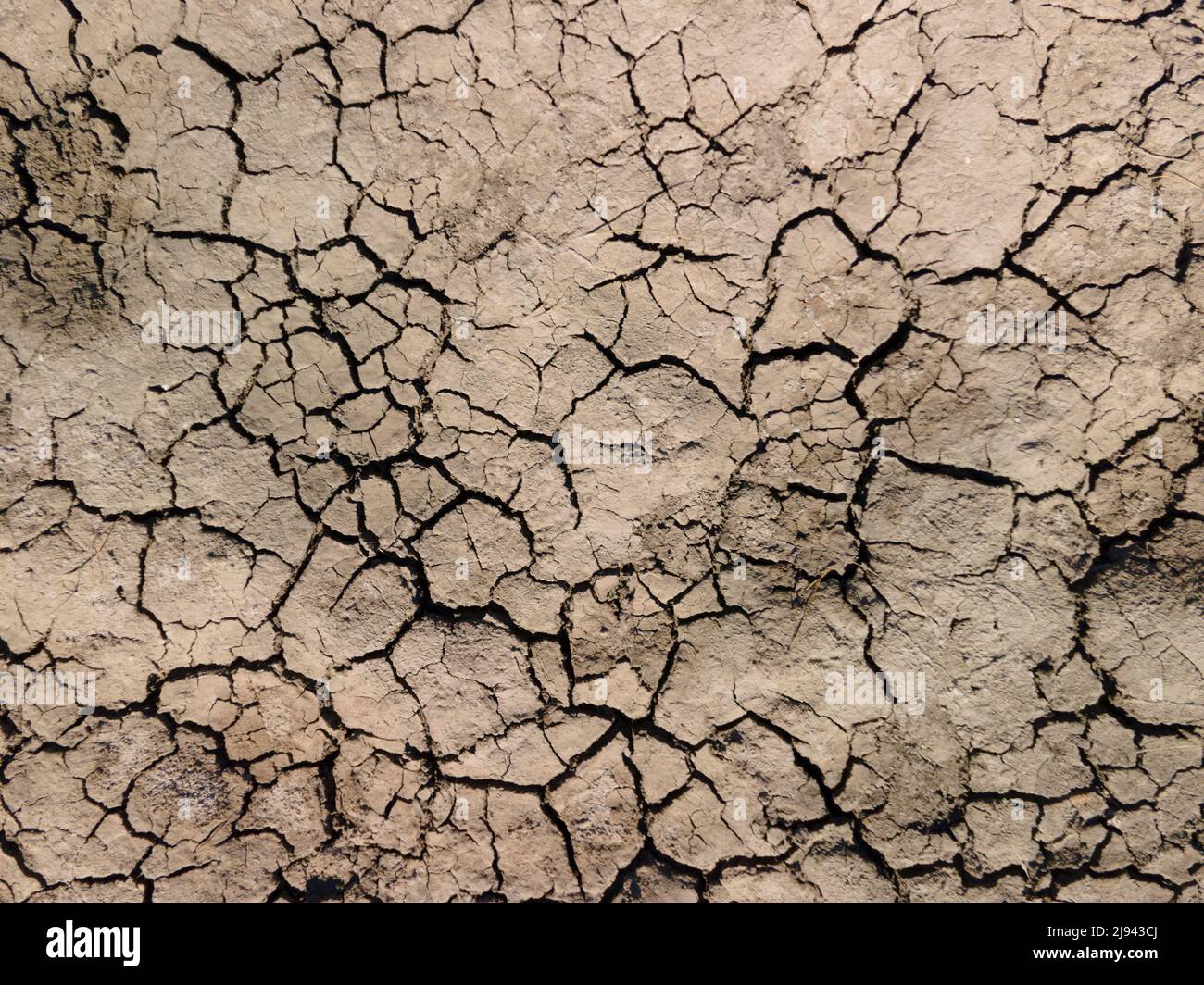 Dry river bed. Empty dry river bed with cracked ground. Global warming ...