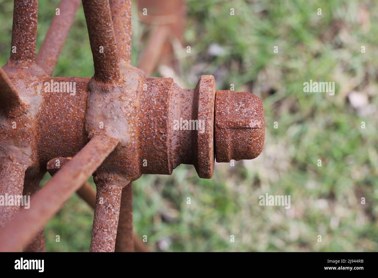 Rusty old farm wagon wheel with lots of rusted iron Stock Photo - Alamy