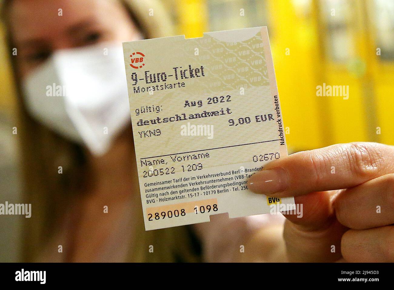 Berlin, Germany. 20th May, 2022. A young woman holds a 9-euro monthly ...