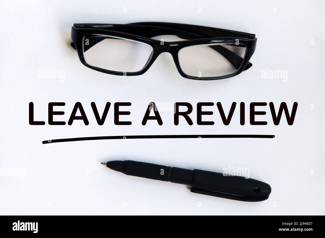 Leave a review text on white cover with pen and glasses background ...
