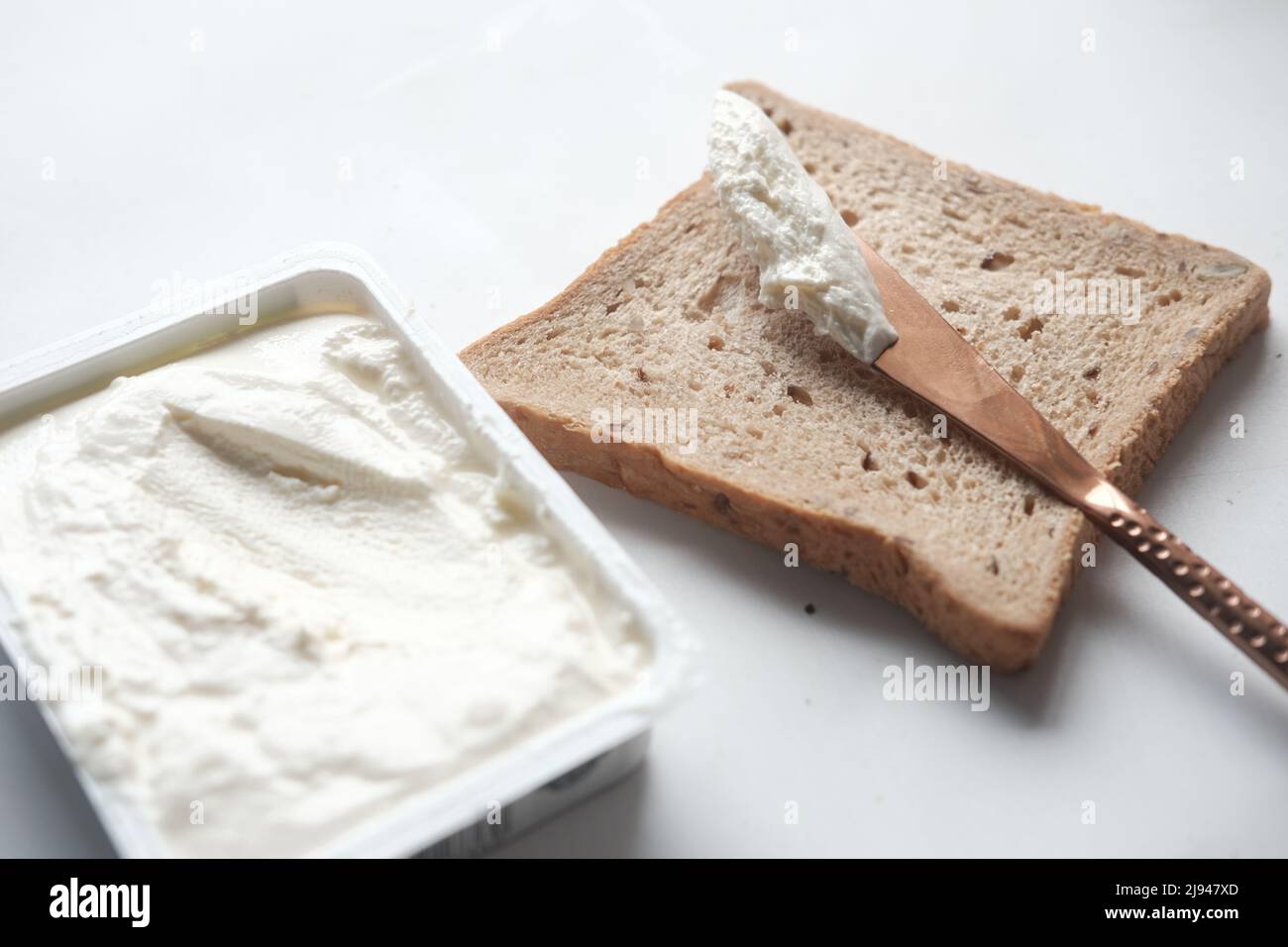 low fact cheese cream spread on a bread Stock Photo - Alamy