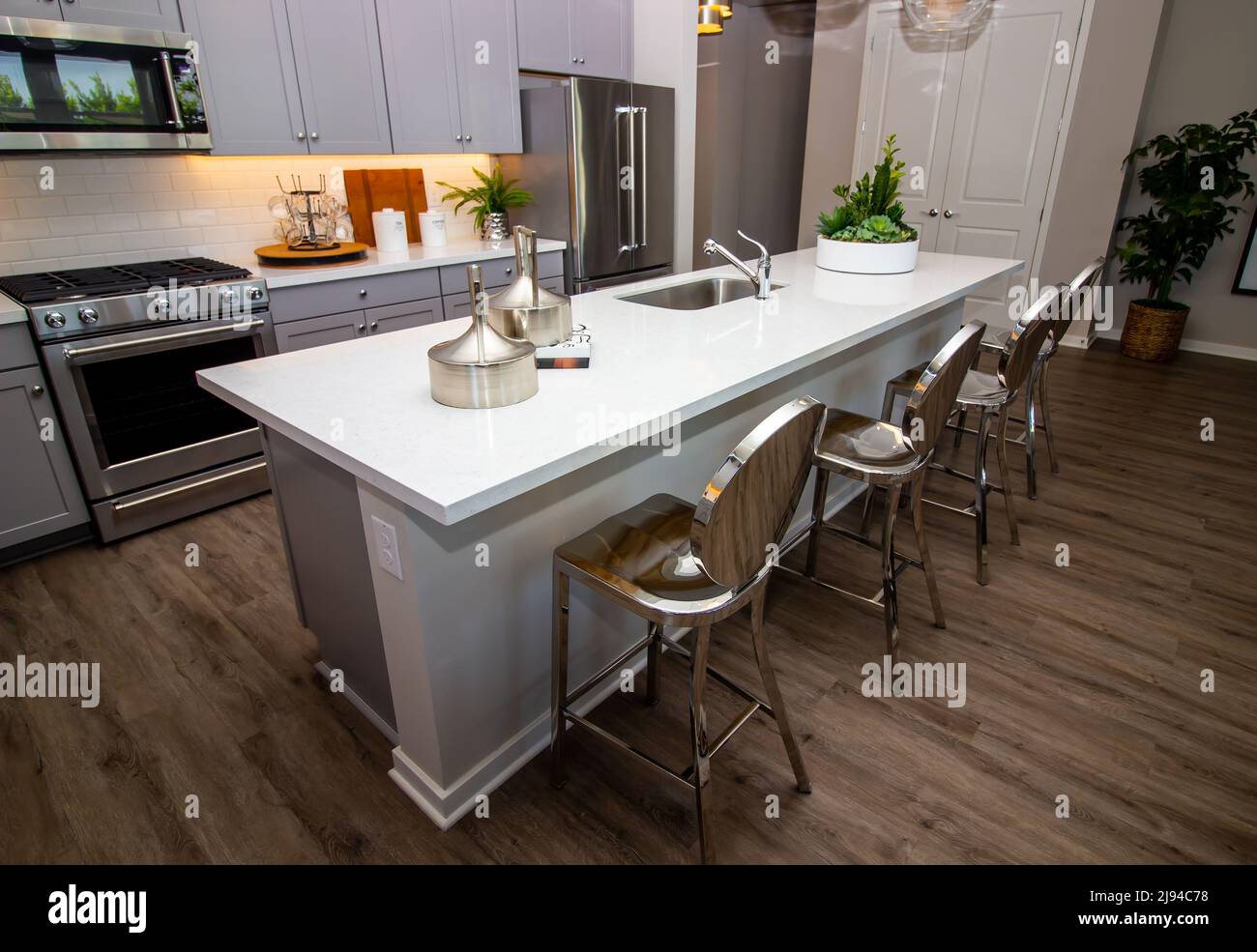 Kitchen Island Counter With Metal Bar Stools Stock Photo - Alamy
