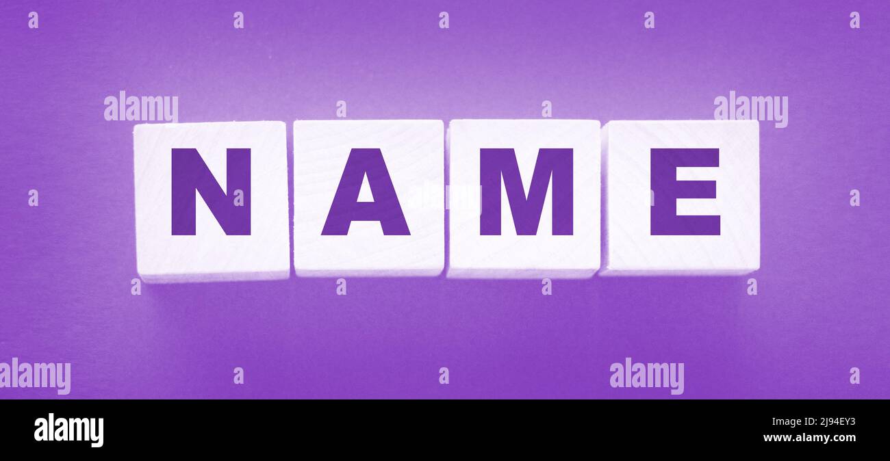Name word with wooden block on black blackboard. Business or personal ...