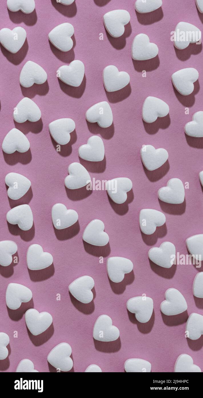 Vertical seamless pattern of white hearts on pink background Stock ...