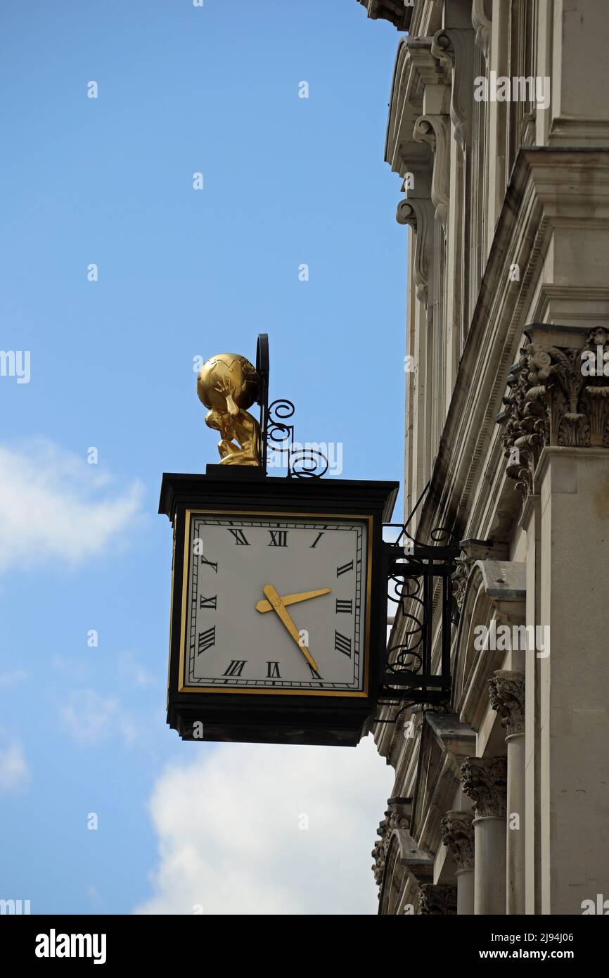 Square faced clock with Roman numerals on Atlas House at Cheapside in ...