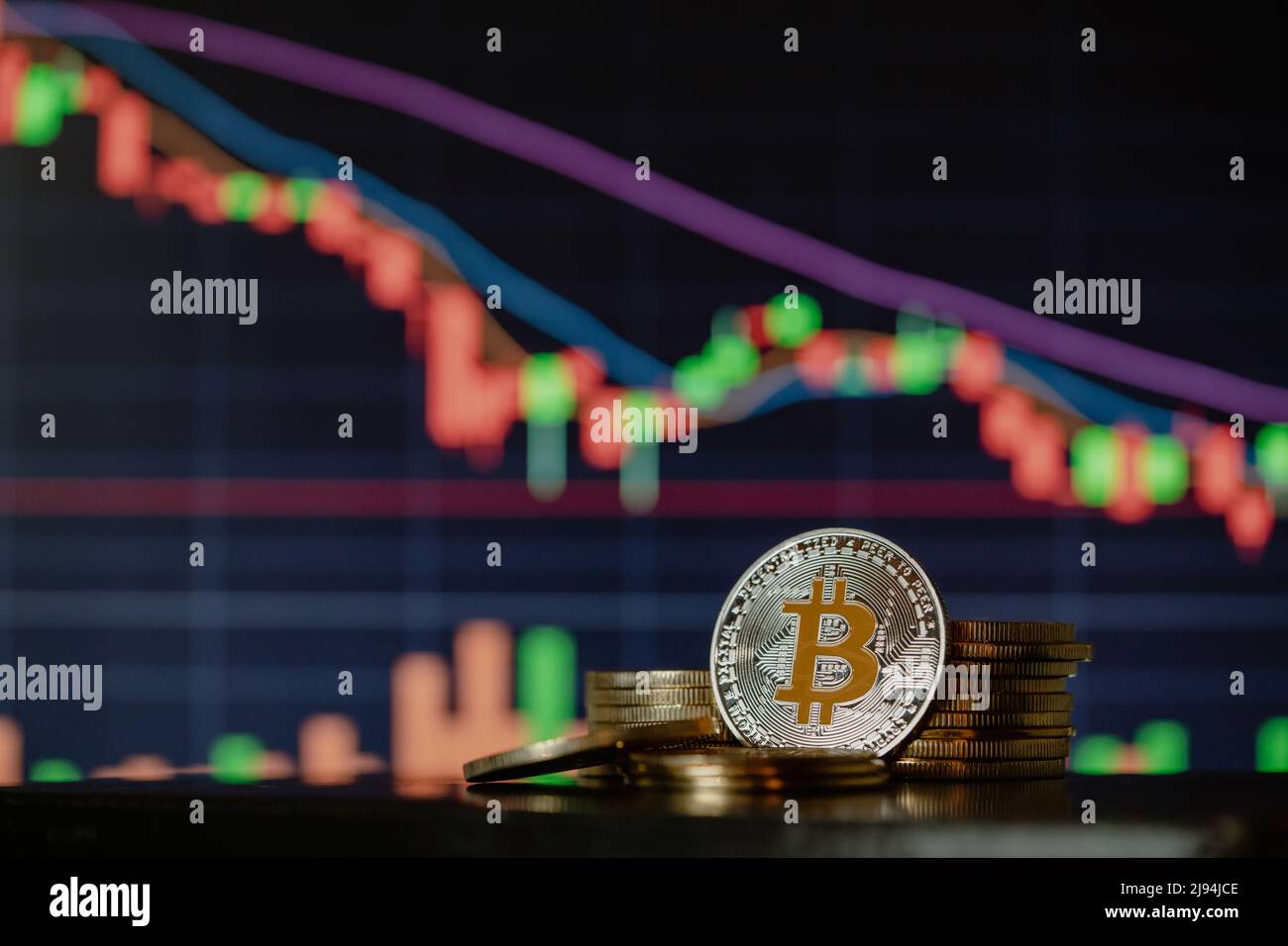 Stack or heap of gold Bitcoins cryptocurrency with candle stick graph ...