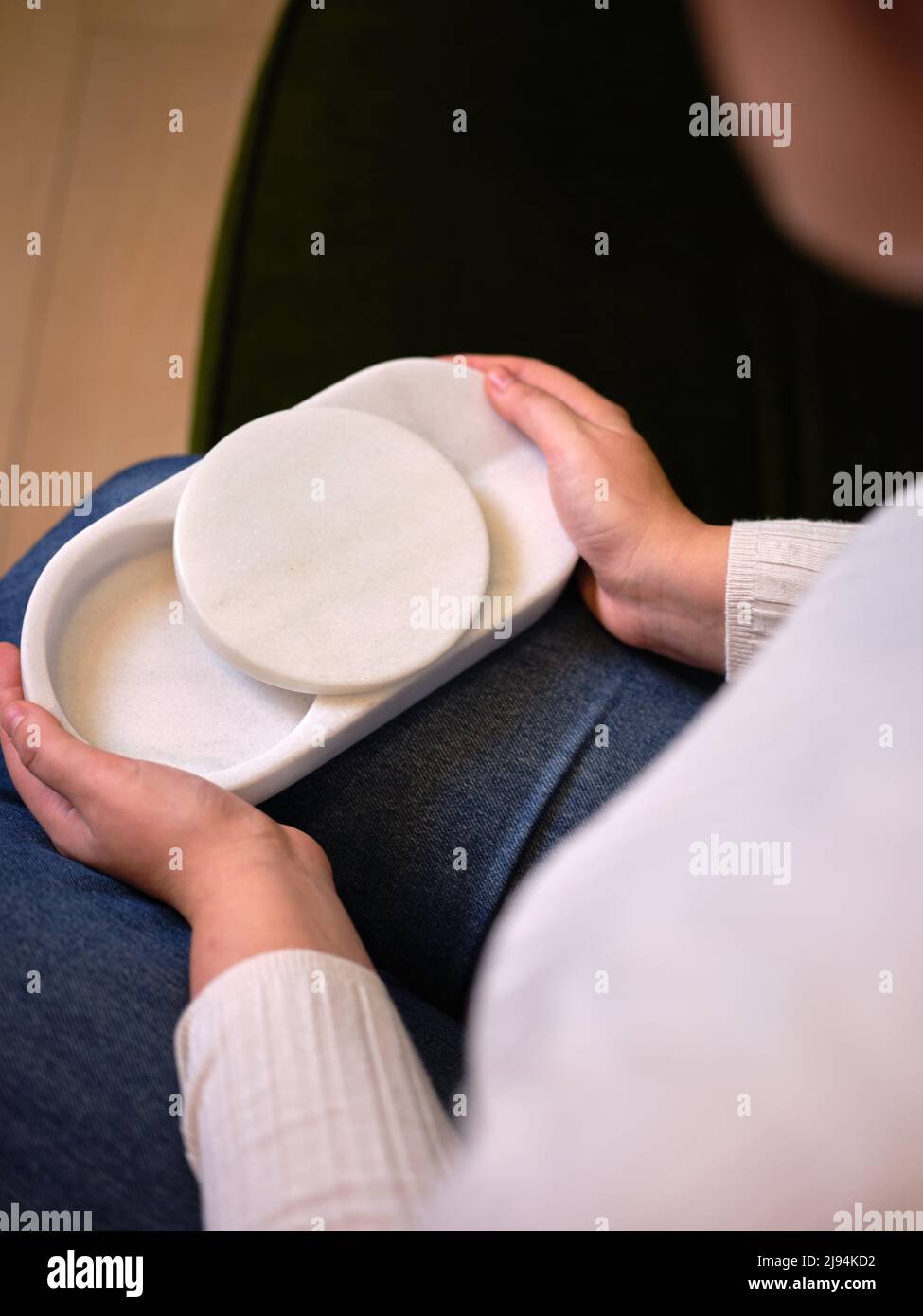 top-down approach to the new product a girl is showing off, white oval ...