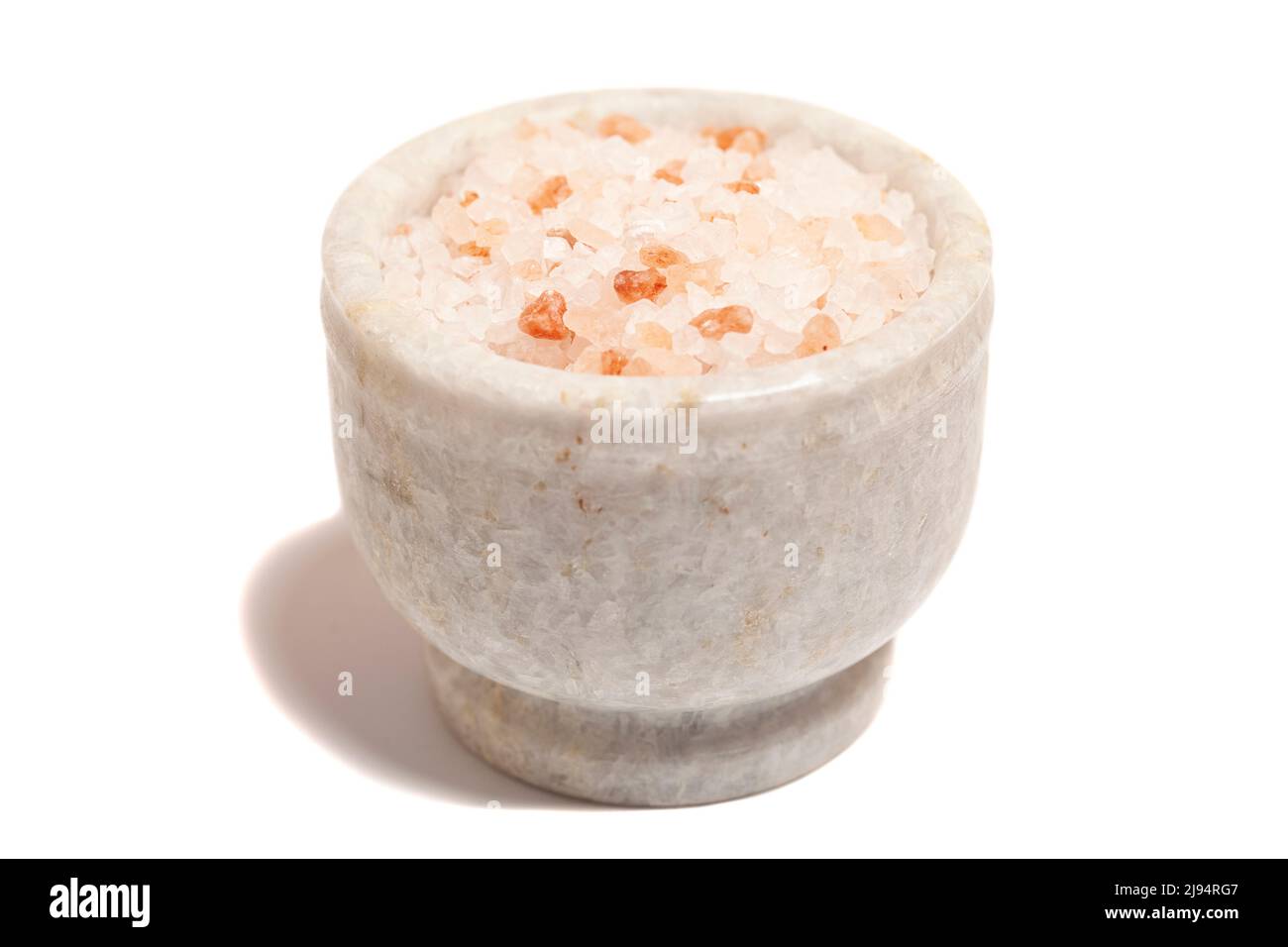 Large crystals pink Himalayan salt in a marble box isolated on white ...