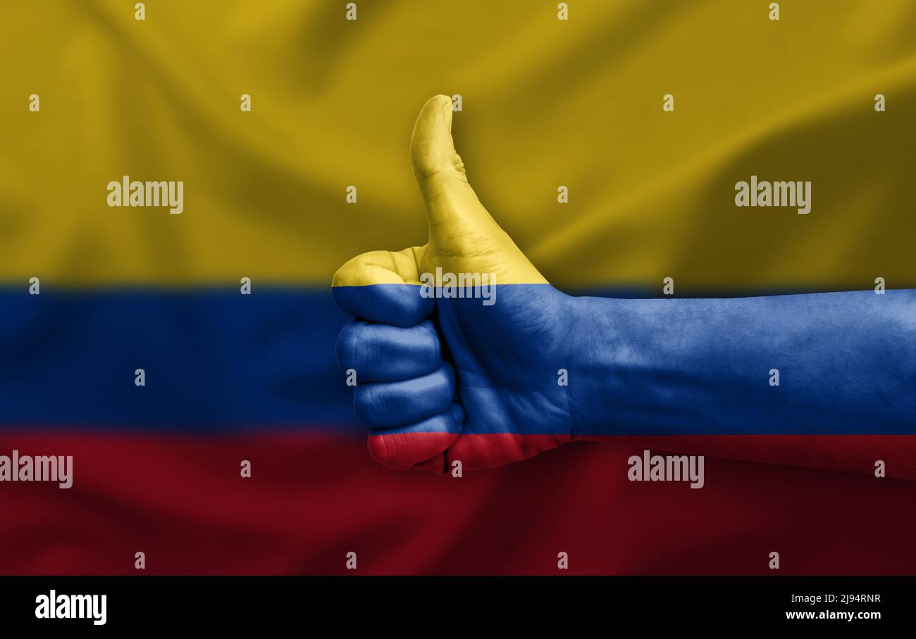 Hand making thumb up painted with flag of colombia Stock Photo - Alamy