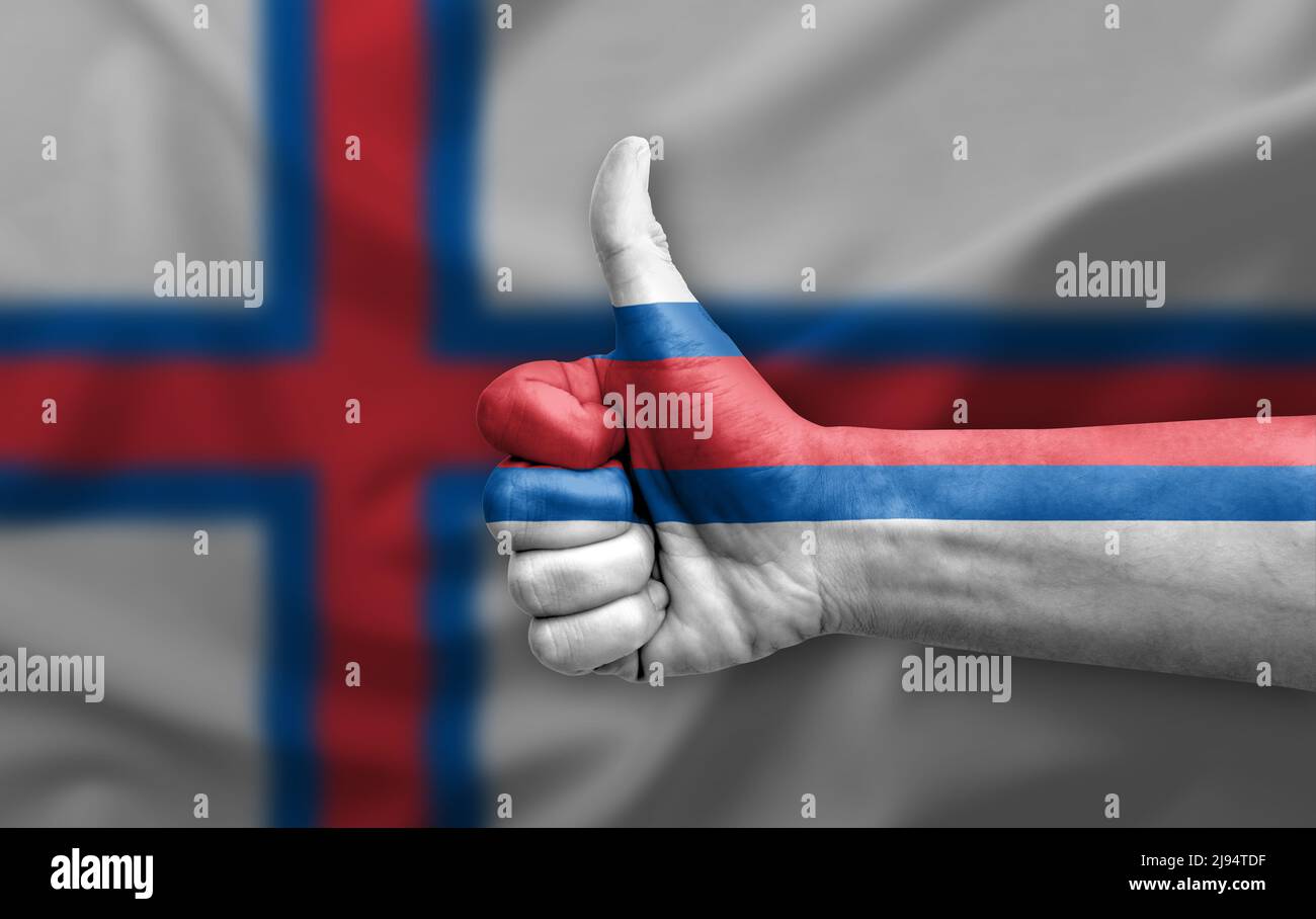Hand making thumb up painted with flag of faroe islands Stock Photo - Alamy