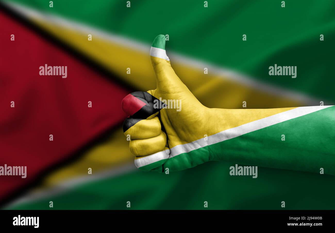 Hand making thumb up painted with flag of guyana Stock Photo - Alamy