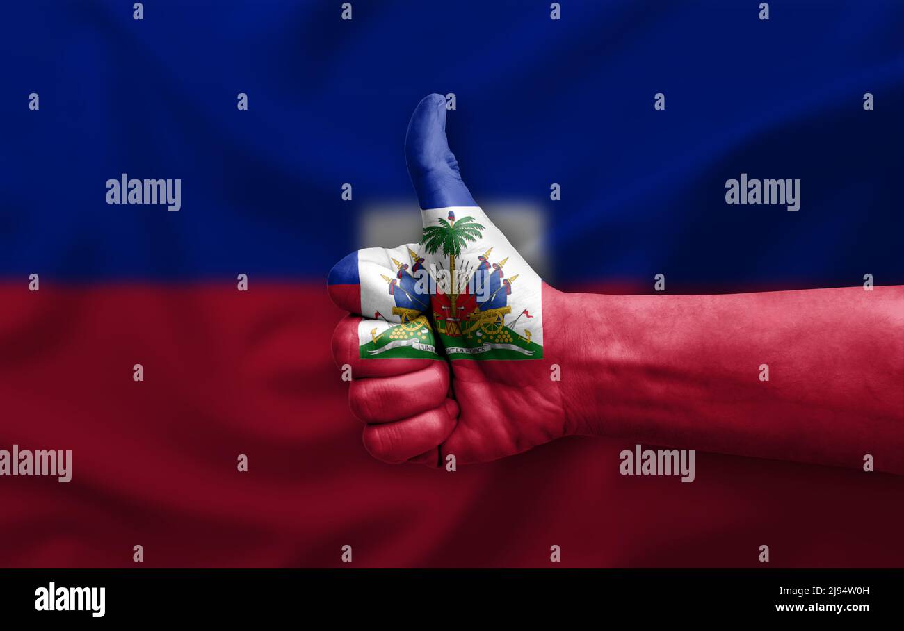 Hand making thumb up painted with flag of haiti Stock Photo - Alamy