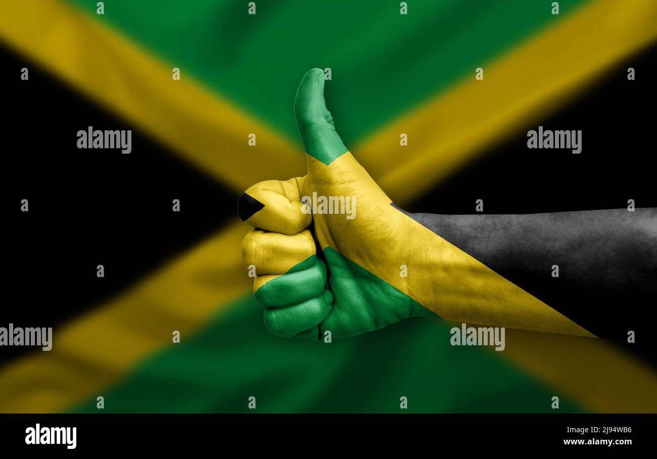Hand making thumb up painted with flag of jamaica Stock Photo - Alamy