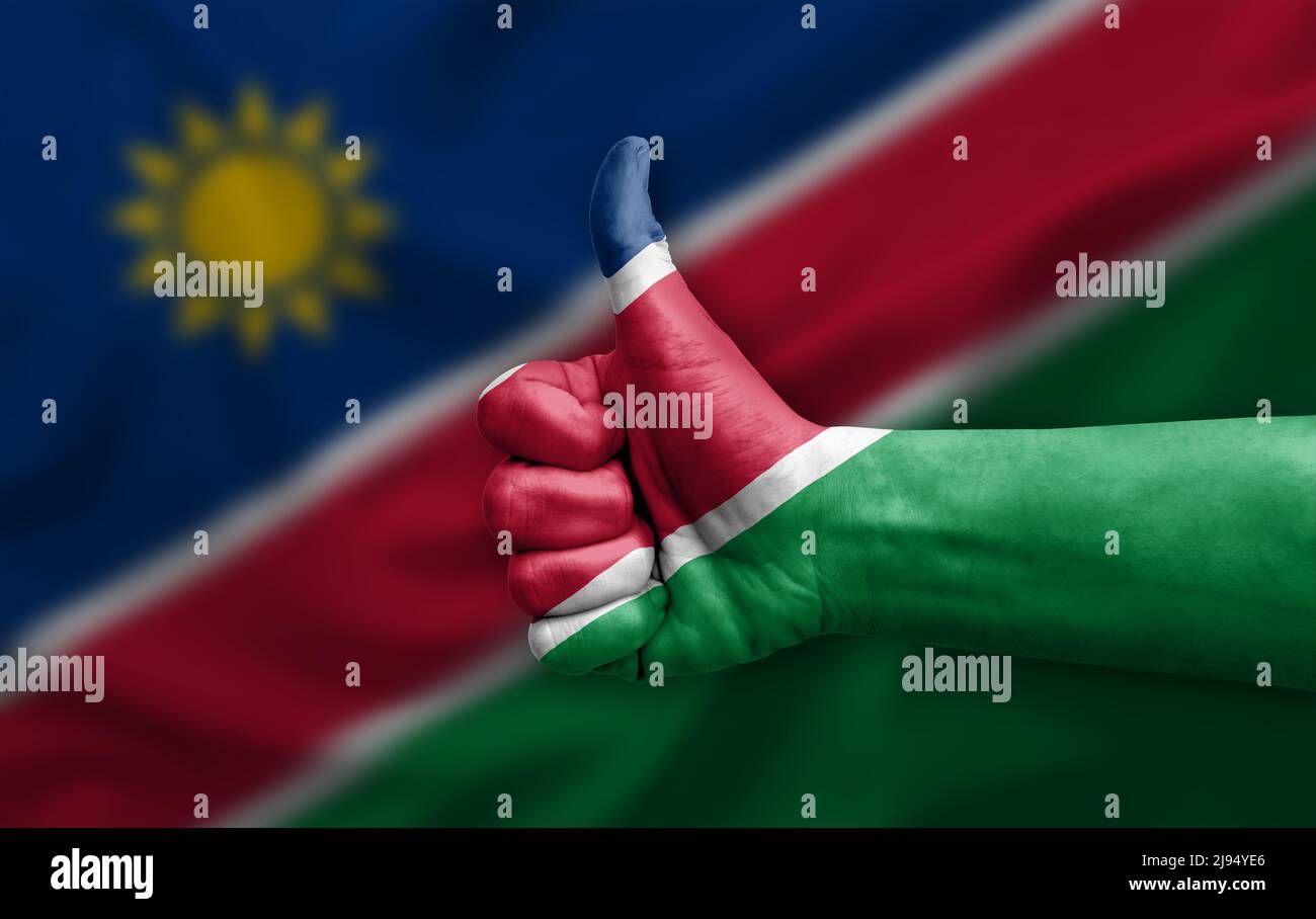Hand making thumb up painted with flag of namibia Stock Photo - Alamy