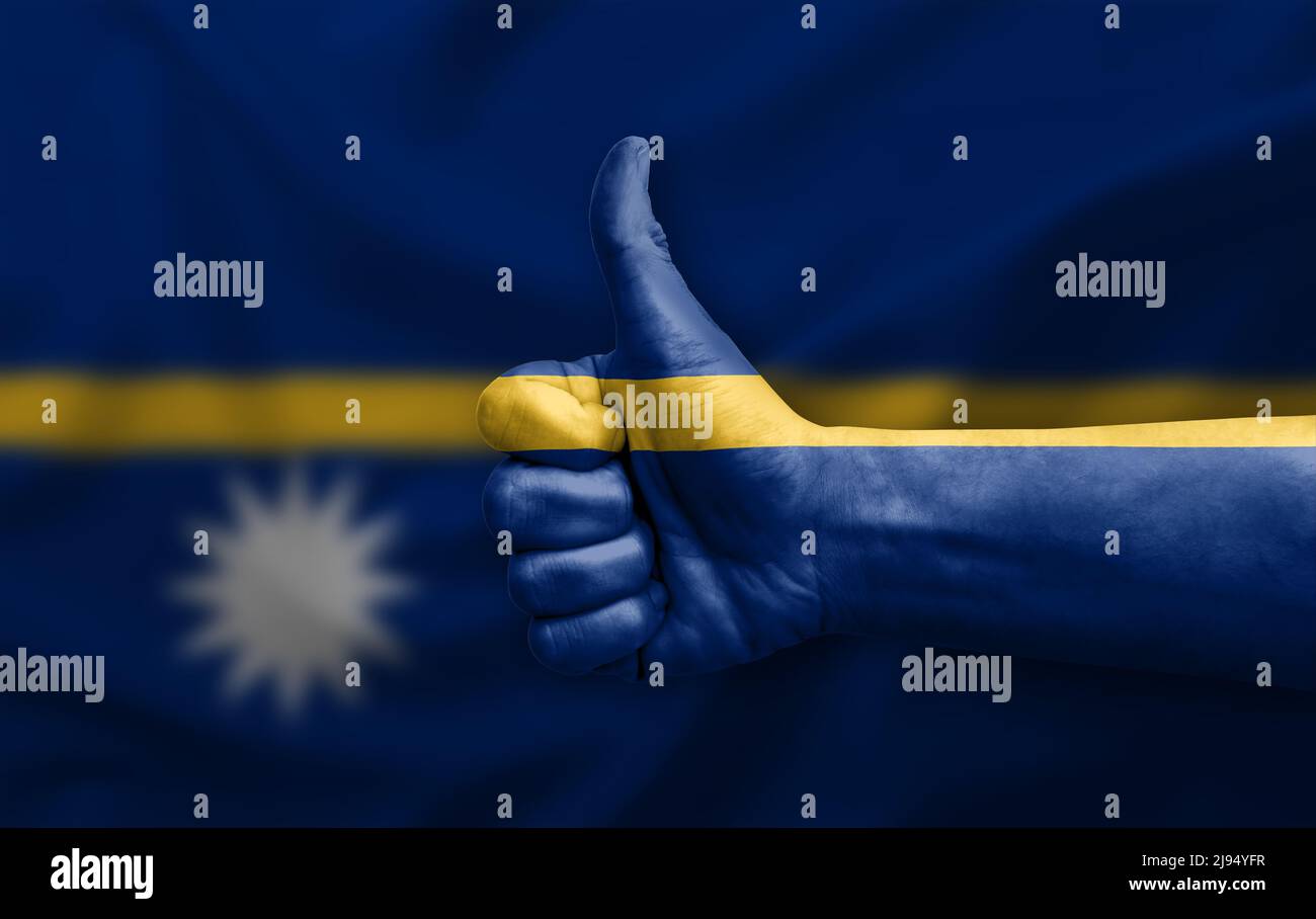 Hand making thumb up painted with flag of nauru Stock Photo - Alamy