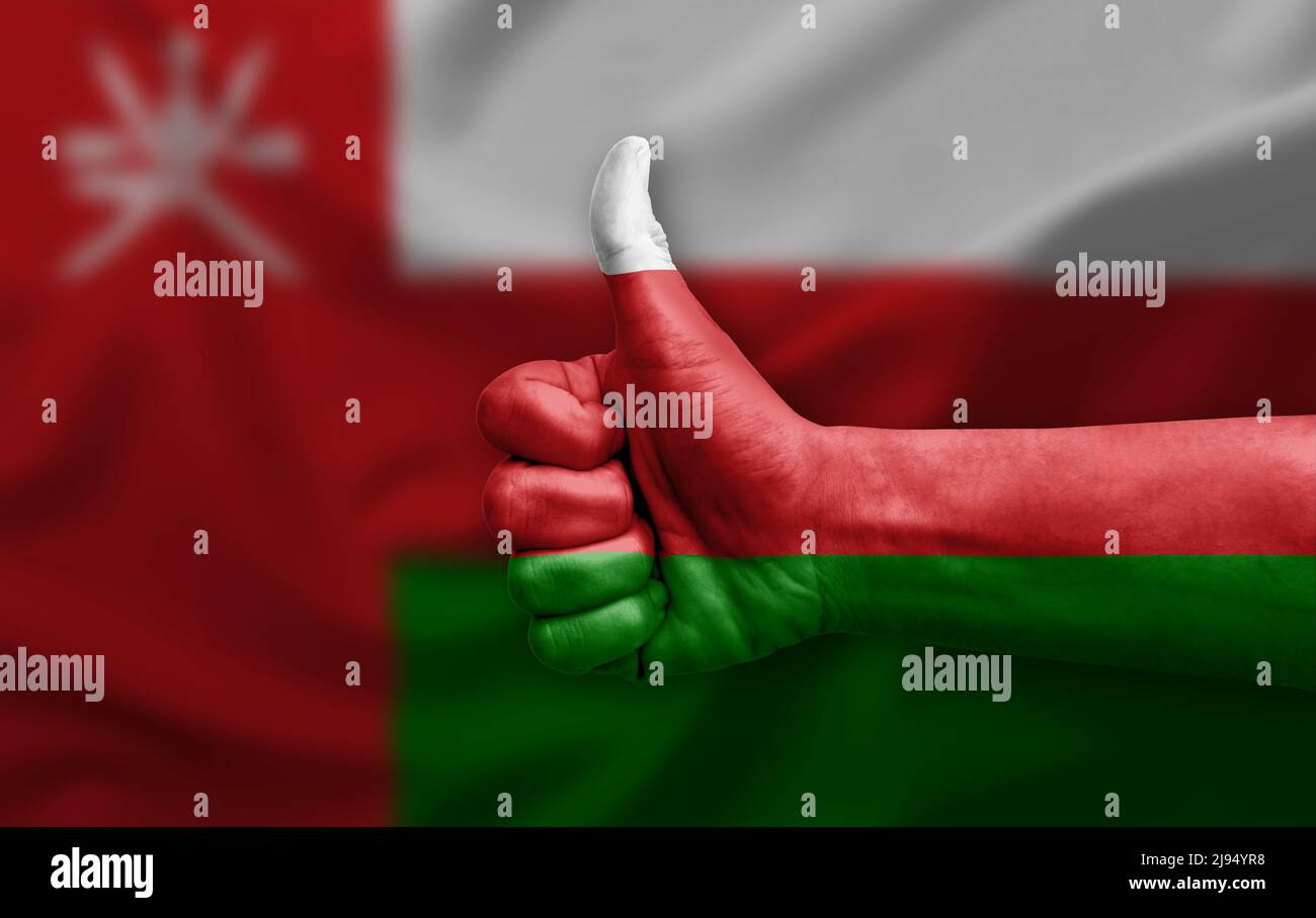 Hand making thumb up painted with flag of oman Stock Photo - Alamy