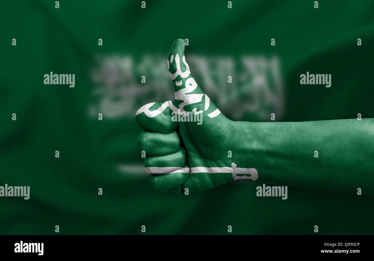 Hand making thumb up painted with flag of saudi arabia Stock Photo - Alamy