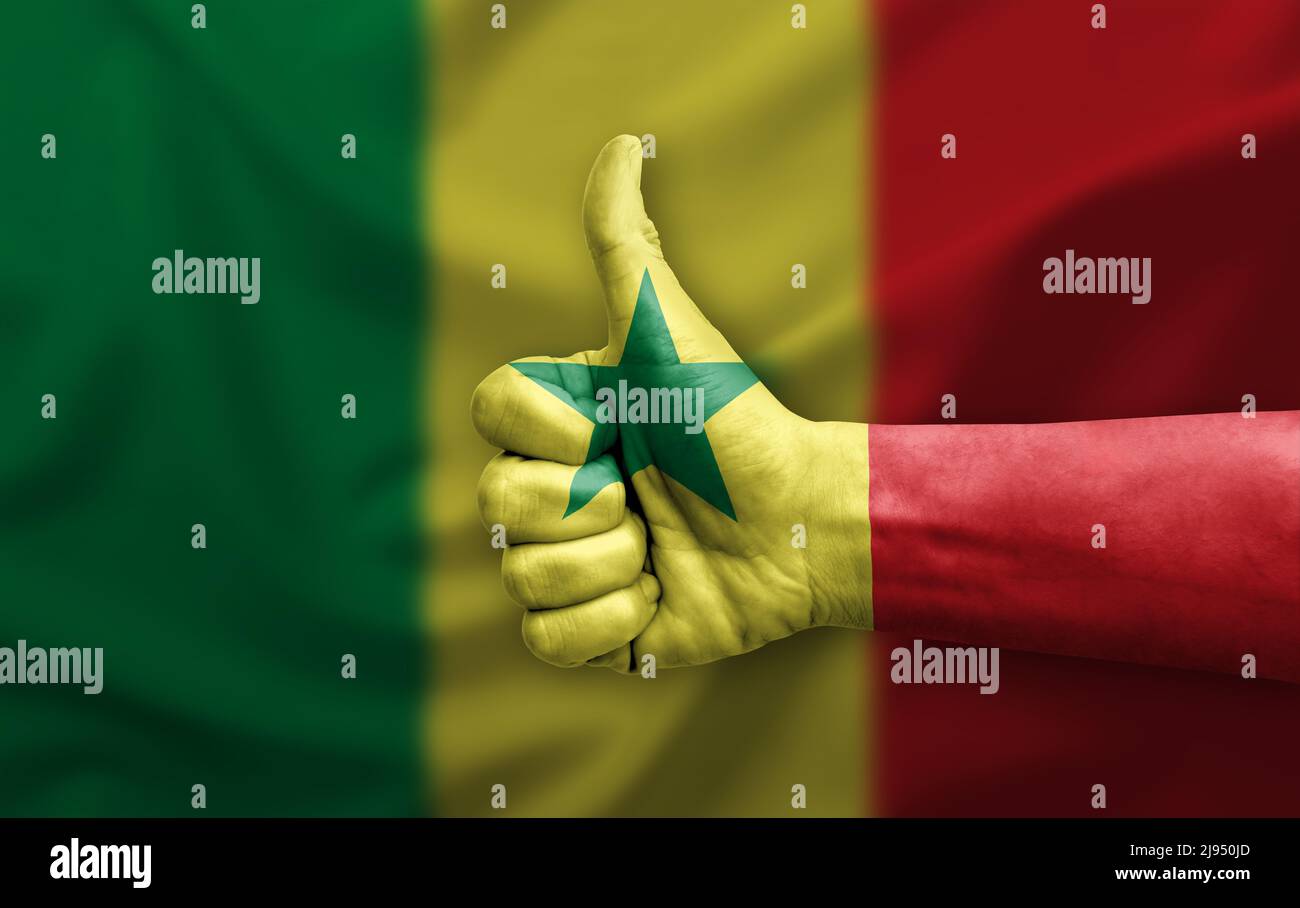 Hand making thumb up painted with flag of senegal Stock Photo - Alamy
