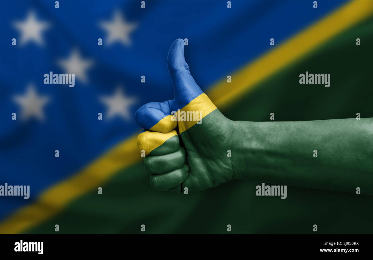 Hand making thumb up painted with flag of solomon islands Stock Photo ...
