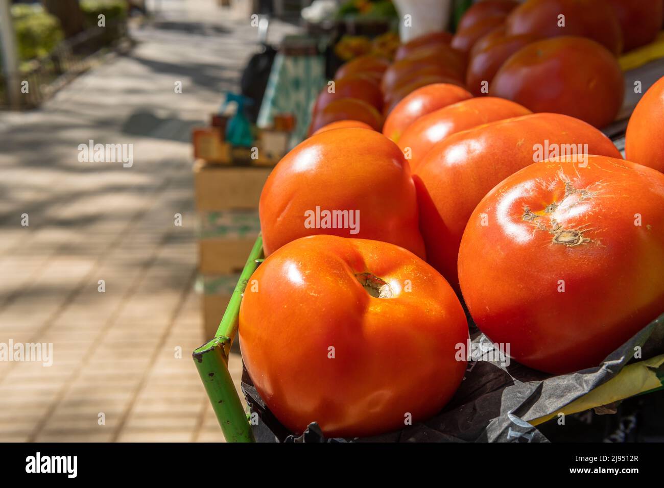 Close-up of tomatoes displayed on the street at a fruit and vegetable ...