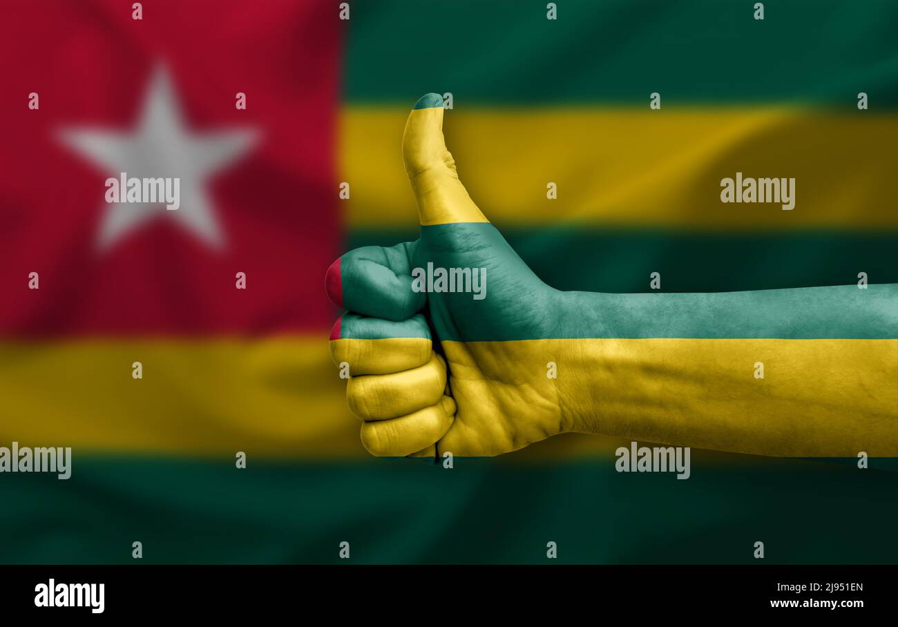Hand making thumb up painted with flag of togo Stock Photo - Alamy