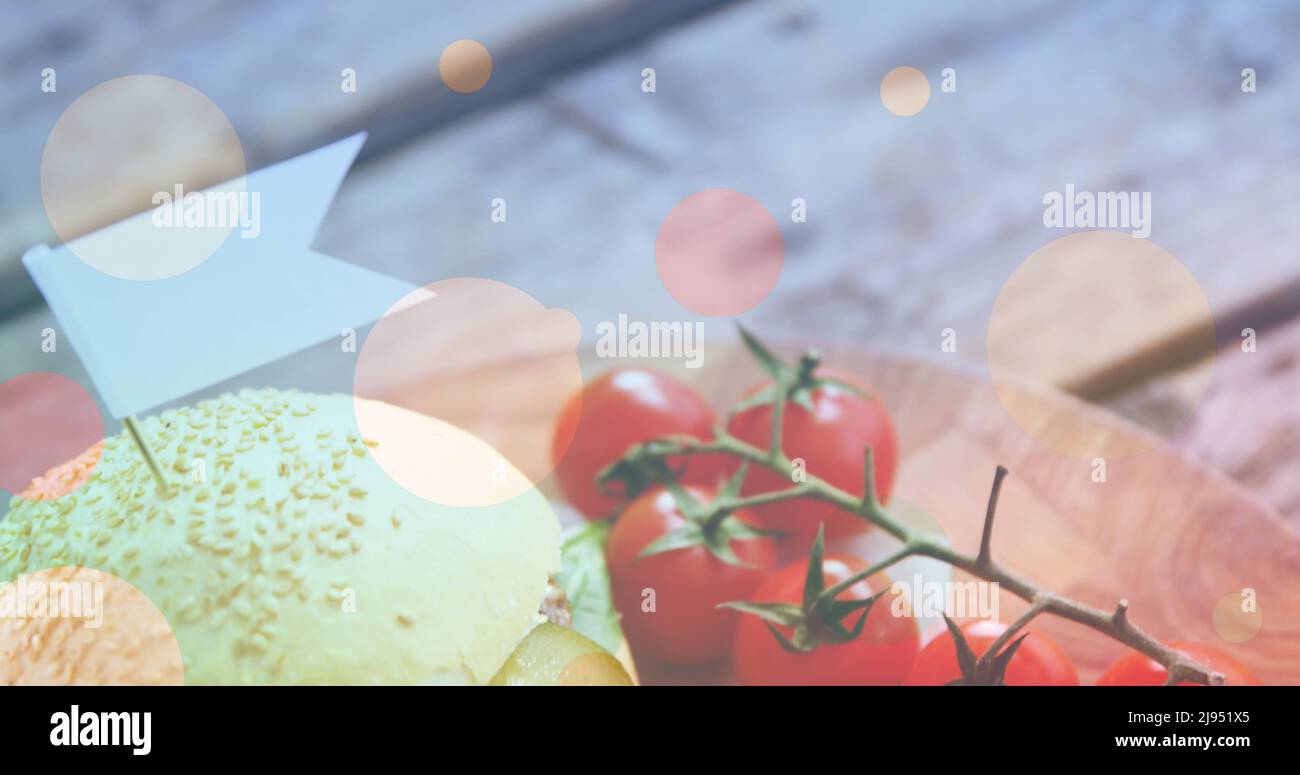 Image of dots over burger, tomatoes and chips Stock Photo - Alamy