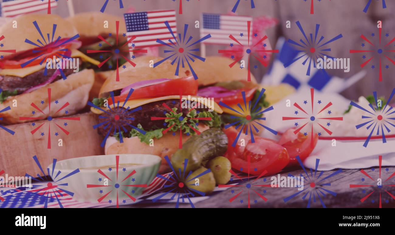 Image of fireworks over burgers with usa flags Stock Photo - Alamy