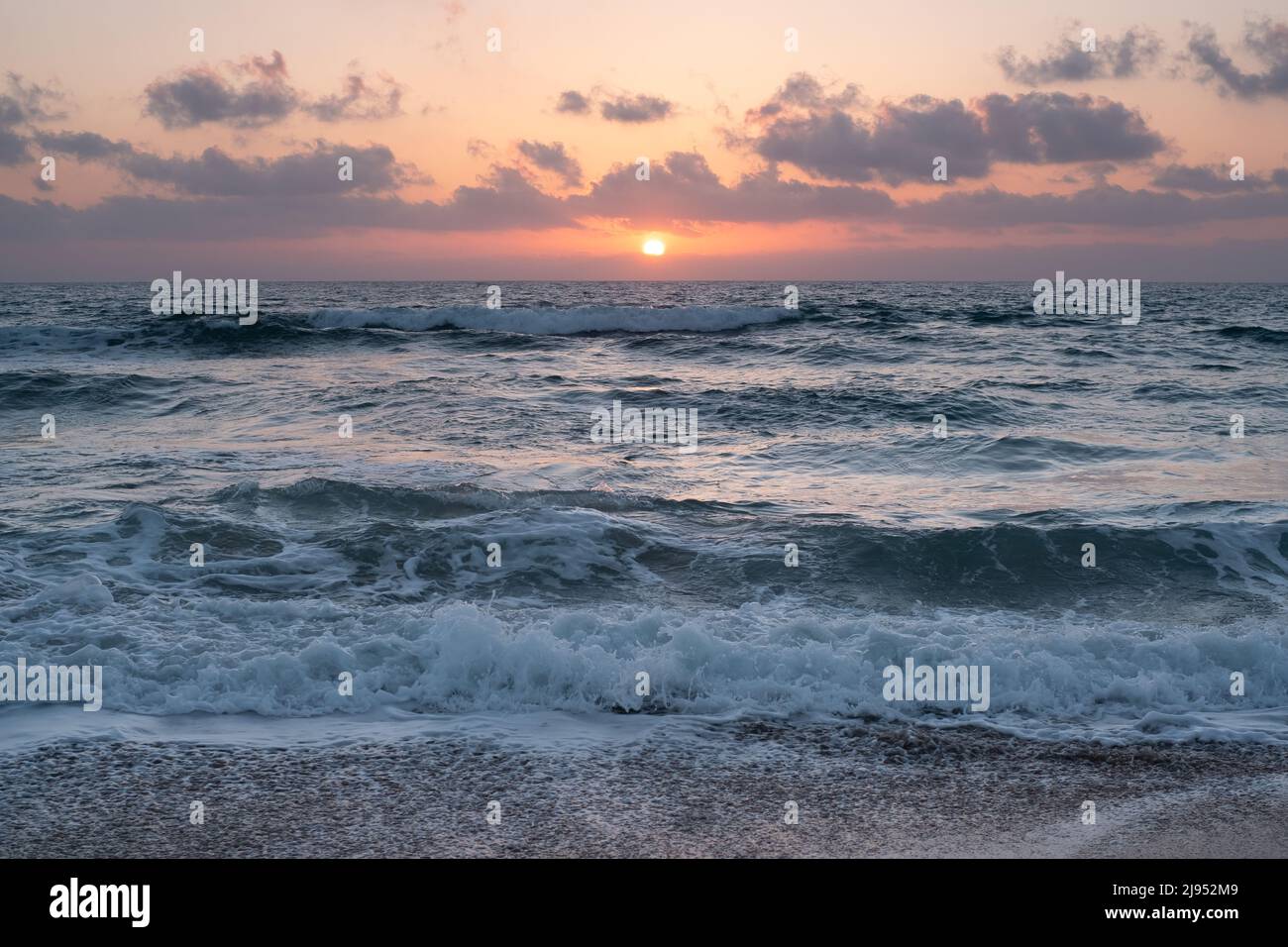 Dusk sunset on a dramatic cloudy sky over the Mediterranean sea. Sea ...