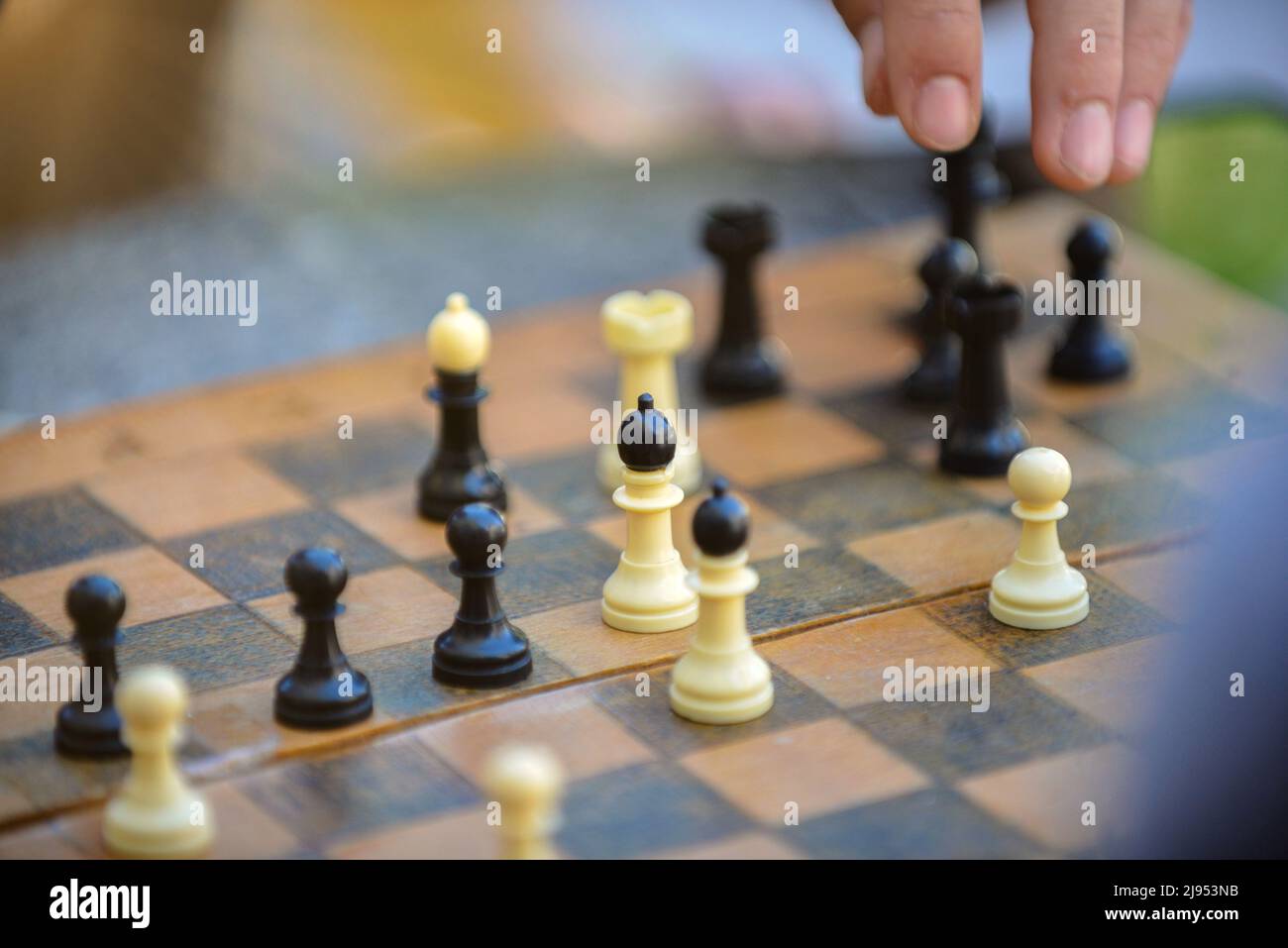 Man playing chess on a table outdoor Stock Photo - Alamy